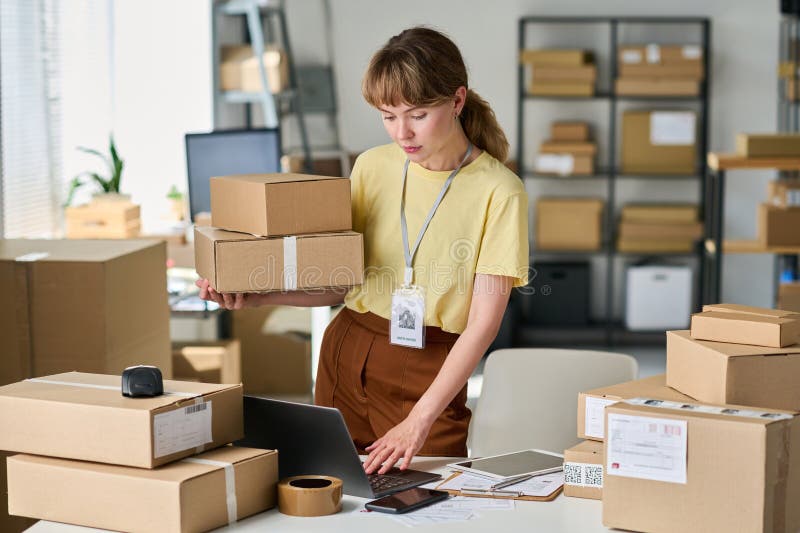 Young Woman in Casualwear Holding Stack of Packed Boxes and Using ...