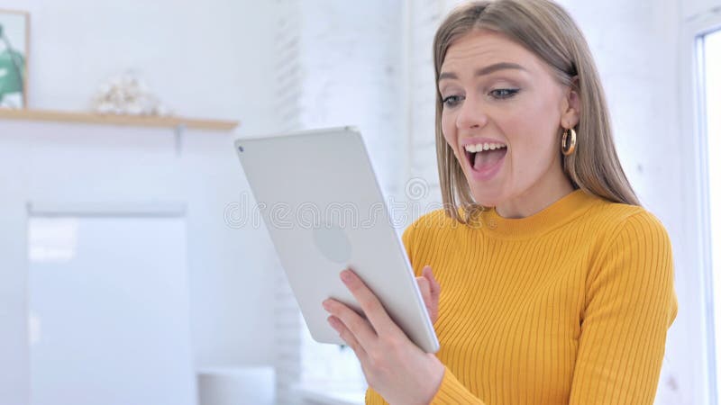 Young Woman Celebrating Success on Tablet Stock Photo - Image of ...