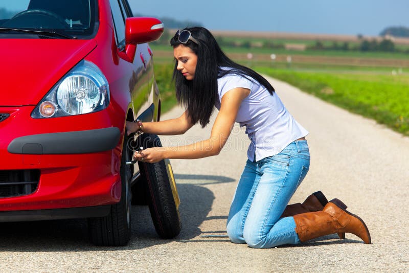 Young Woman Changing Tire Royalty Free Stock Photos - Image: 11860958