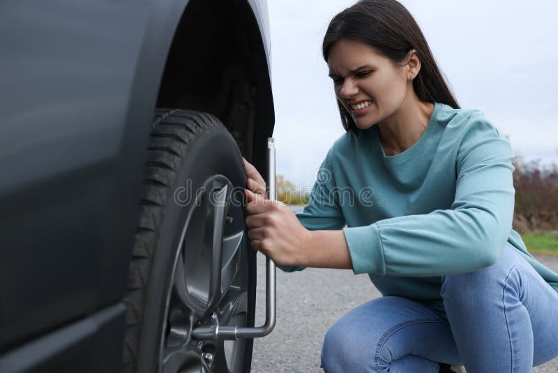 Man Changing Car Tire Near Road, Focus on Emergency Warning Triangle ...