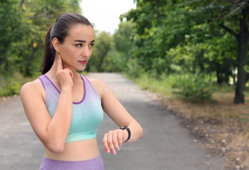 Young Woman Pulse after Training in Park. Space for Text Stock Image ...