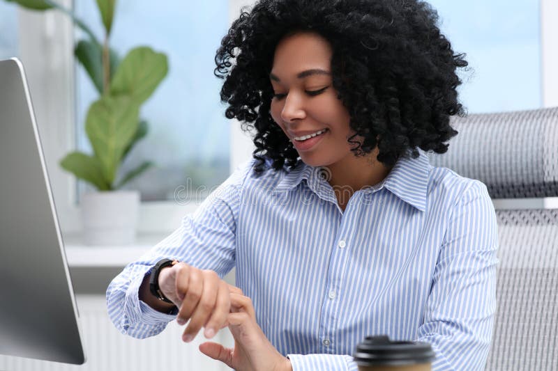 Young Woman Checking Time on Watch at Workplace in Office Stock Image ...
