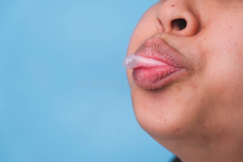 Young Woman Chewing Gum and Blowing Bubble Gum on Blue Background Stock ...