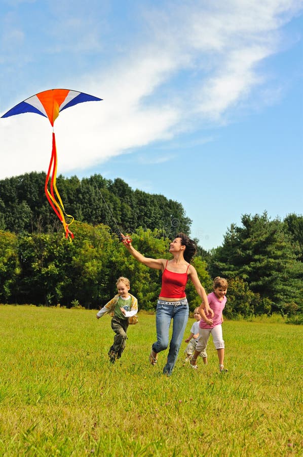 Young Woman and Children Flying a Kite Stock Image - Image of people ...