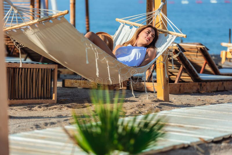 Young Woman Chilling on Deck Chair on the Beach Stock Photo - Image of ...