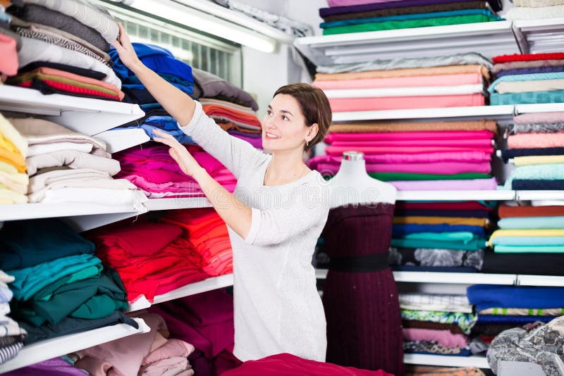 Woman choosing fabric stock photo. Image of option, choice - 265058070