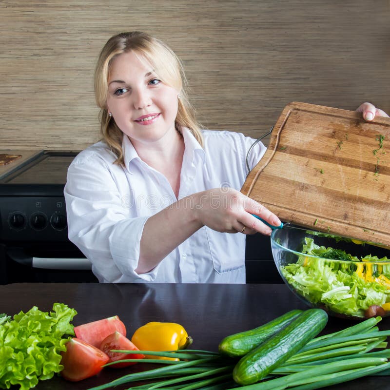 Young Woman Chops Vegetables in the Kitchen. Stock Photo - Image of ...