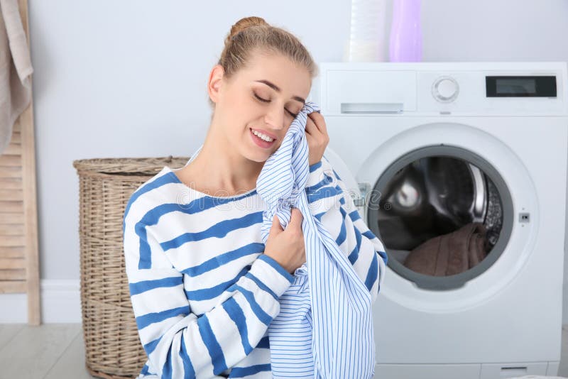 Young Woman with Clean Clothes in Bathroom. Stock Photo - Image of ...