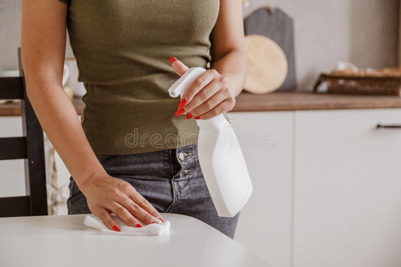 Young Woman Cleaning Table with Spray Rag in Kitchen Stock Photo ...