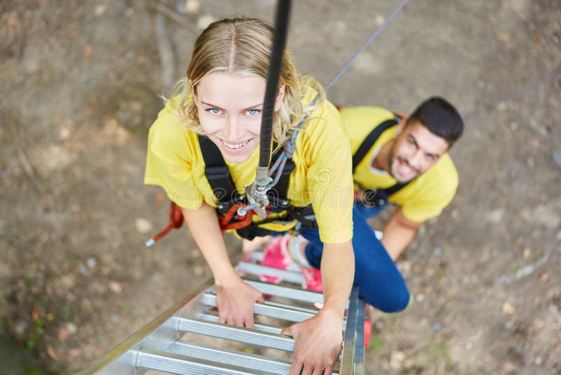 Young Woman in Climbing Park Roped on the Ladder Stock Photo - Image of ...