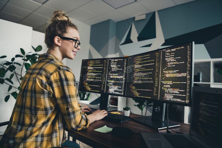 Young Female Programmer Working on Coding Tasks at a Modern Workspace ...