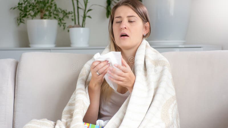 Photo of Young Woman with Cold Sneezing in Tissue Stock Photo - Image ...