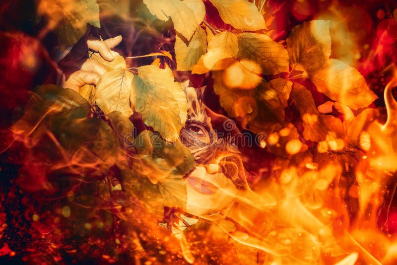 Young Woman with a Colorful Feather Face Mask. Fire Effect. Stock Photo ...