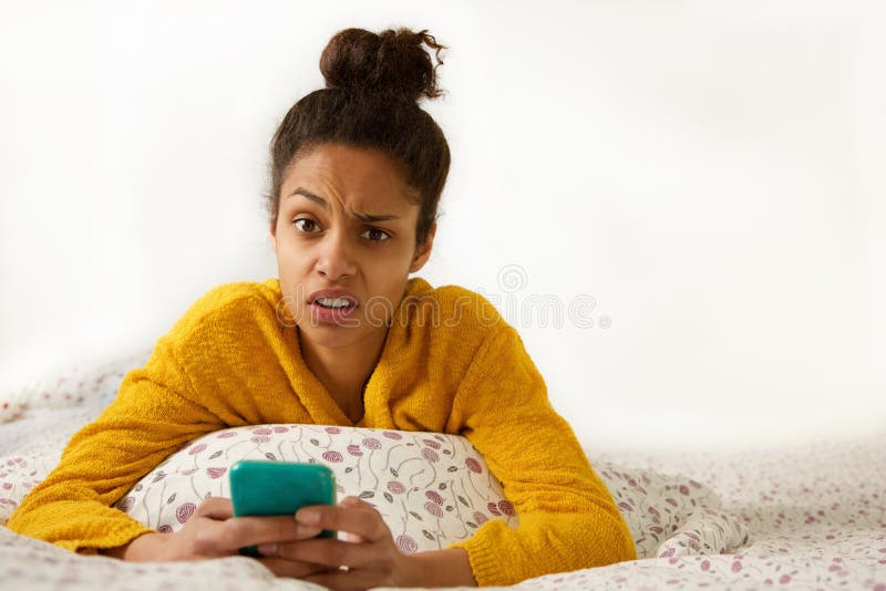 Young Woman with Confused Face Expression Sitting in Bed Stock Photo ...