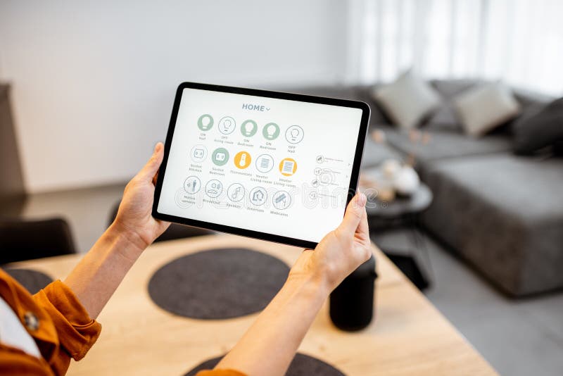 Woman Controlling Smart Devices with a Digital Tablet at Home Stock ...