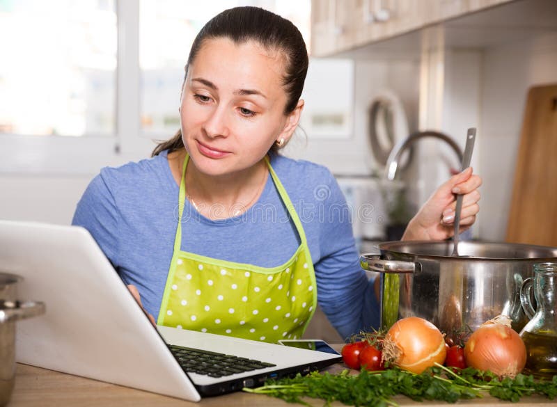 Woman Cooking Recipe from the Internet Stock Image - Image of reading ...