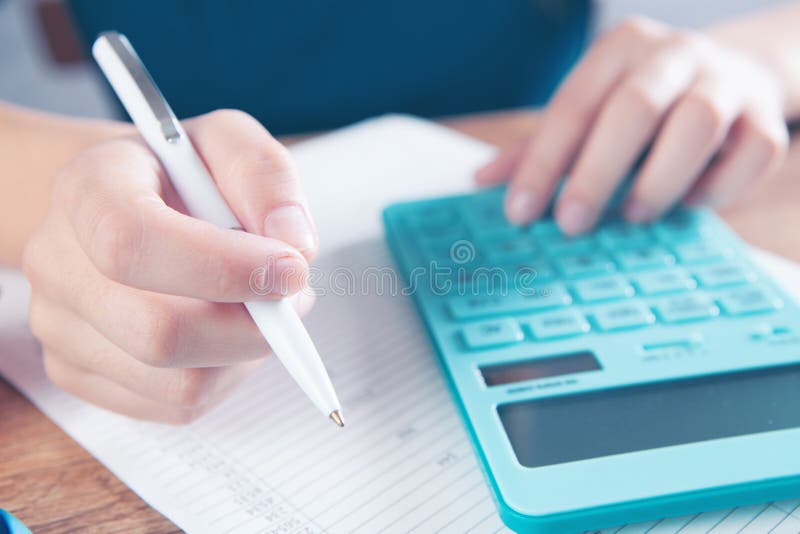 Young Woman Counts on Calculator and Makes Notes on Papers Stock Image ...
