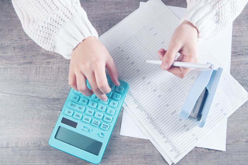 Young Woman Counts on Calculator and Makes Notes on Papers Stock Image ...