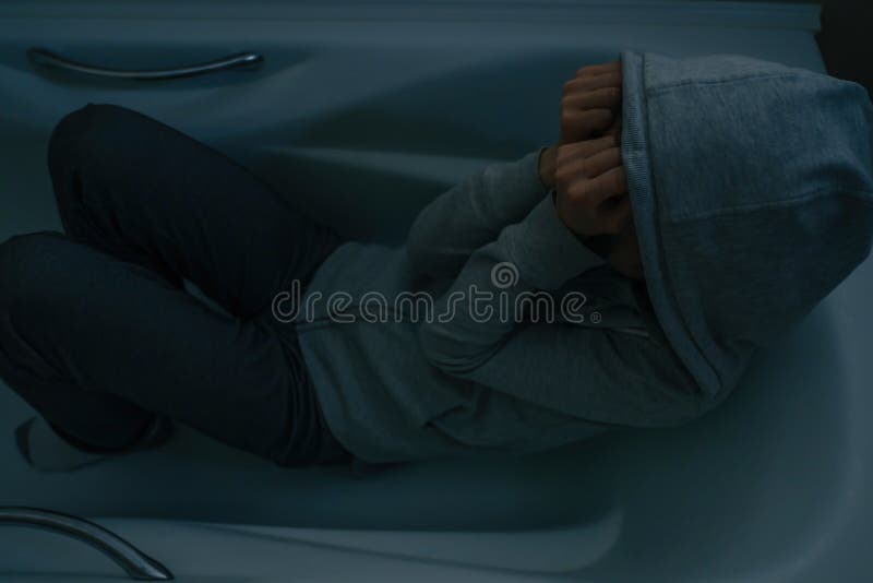 A Young Woman is Crying in the Bathroom in Clothes. the Young Woman is ...