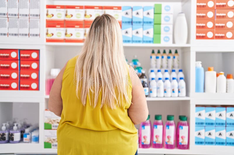 Young Woman Customer Looking Shelving on Back View at Pharmacy Stock ...