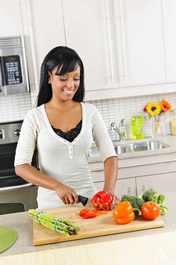 Young Woman Cutting Vegetables in Kitchen Stock Image - Image of ...