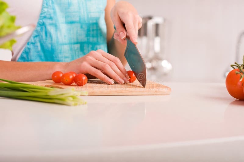 Young Woman Cutting Vegetables in a Kitchen Stock Photo - Image of ...