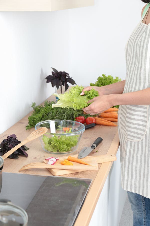 Young Woman Cutting Vegetables in the Kitchen Stock Photo - Image of ...