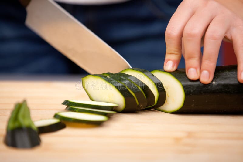 Young Woman Cutting Zucchini Stock Photo - Image of cooking, hand: 58525916