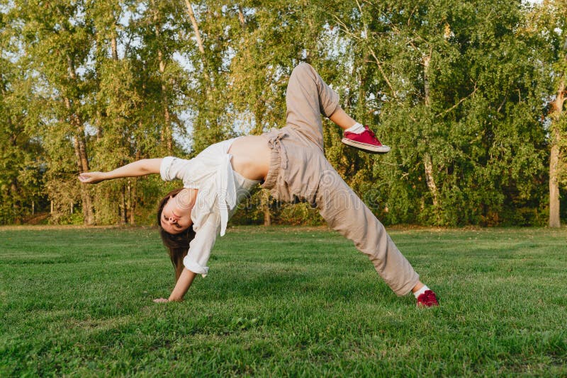 Young Woman Dancing Outdoors on Green Grass Stock Image - Image of ...