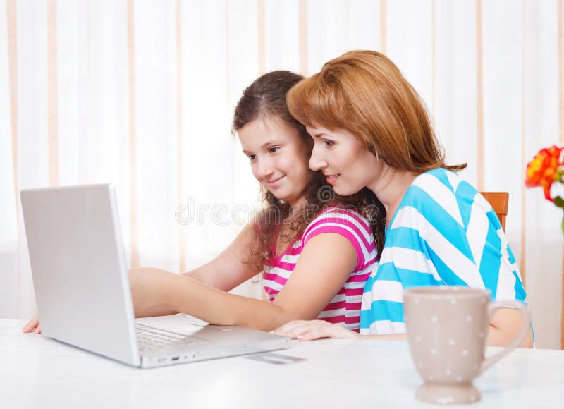 Mother and Daughter at Home Using Computer Stock Photo - Image of ...