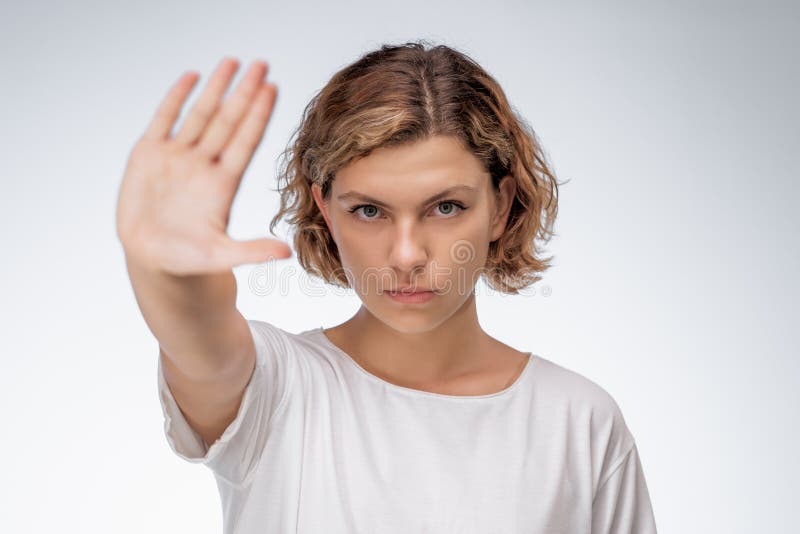 Serious Woman Making Stop Gesture with Hand Extended on White ...