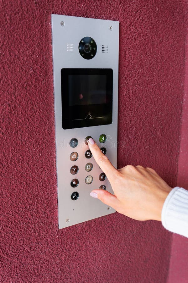 A Young Woman Dials the Apartment Code on the Panel of an Electronic ...