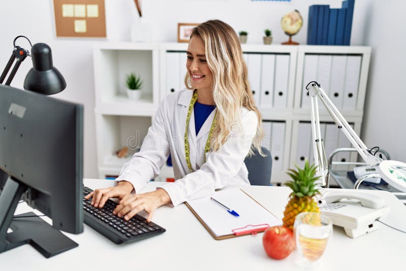 Young Woman Dietician Smiling Confident Using Computer at Clinic Stock ...