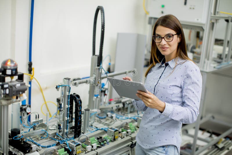 Young Woman with Digital Tablet in the Electronics Workshop Stock Image ...