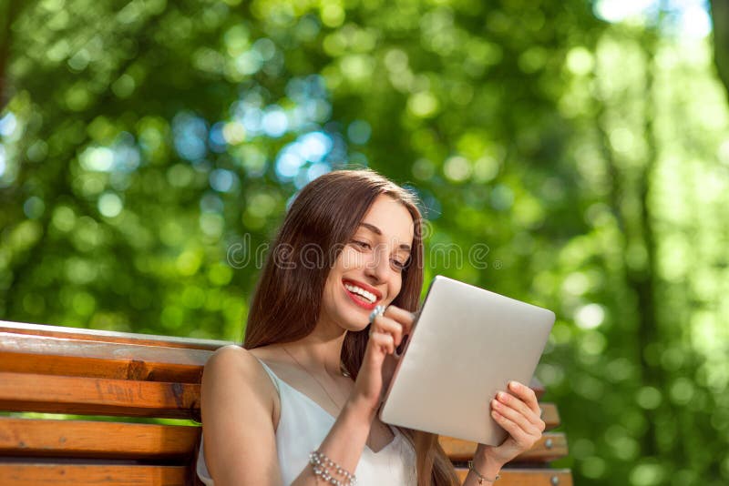 Young Woman with Digital Tablet in the Park Stock Photo - Image of ...