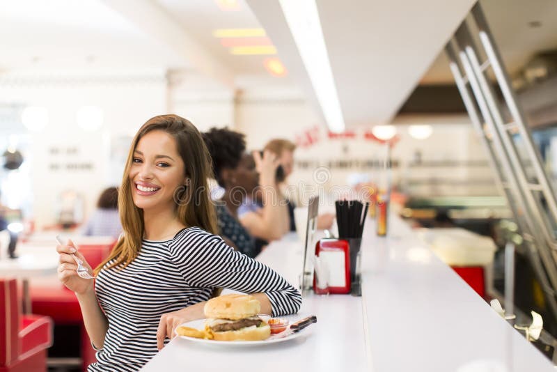 Young woman in diner stock photo. Image of young, junk - 77360730