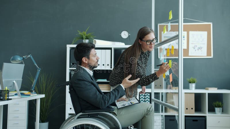 A Disabled Man On A Wheelchair In The Office Young Man With