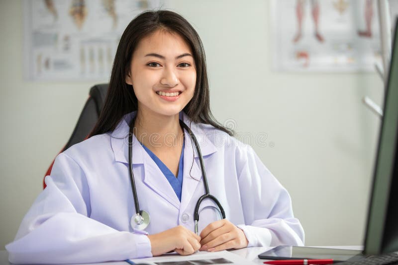Young Woman Doctor Smiling and Working at Office Stock Image - Image of ...