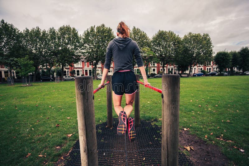 Young Woman Doing Dips in the Park Stock Image - Image of happy, nature ...