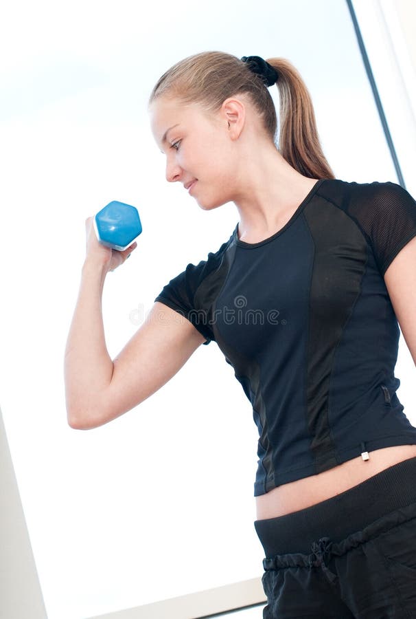 Young Woman Doing Dumbbell Exercises Stock Image - Image of black, cute ...