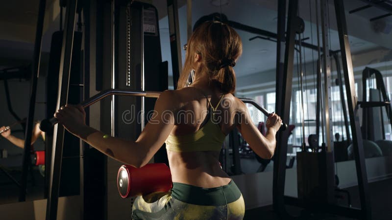 Young Woman Doing Exercise for Back on Training Machine Stock Footage ...