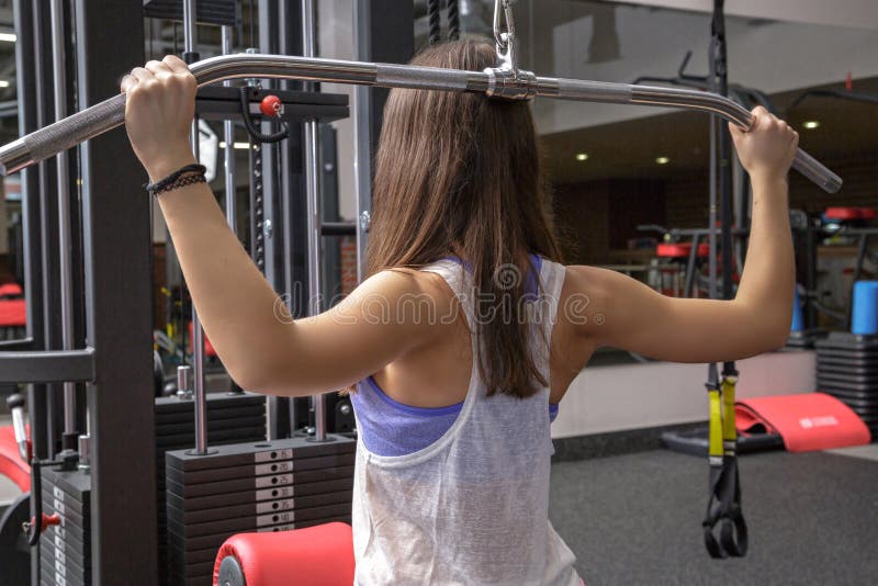 Young Woman Doing Exercises on Training Apparatus. Stock Photo - Image ...