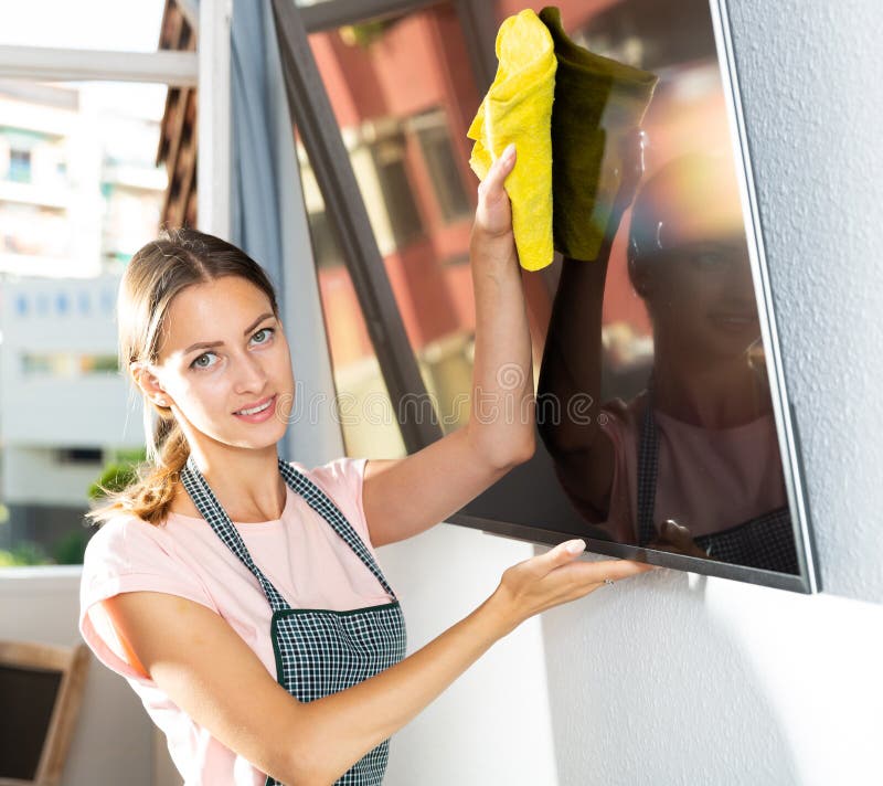 Woman washing TV screen stock photo. Image of cleanup - 208601514