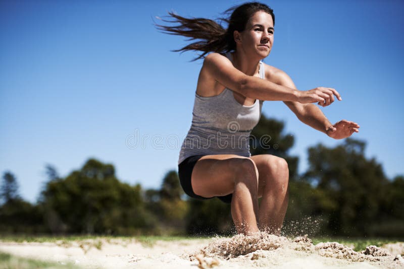 Going As Far As she Can. a Young Woman Doing Long Jump. Stock Image ...