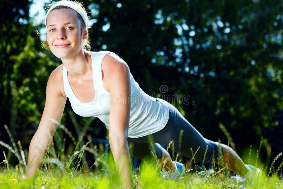 Young Woman Doing Push Ups on Green Stock Photo - Image of routine ...