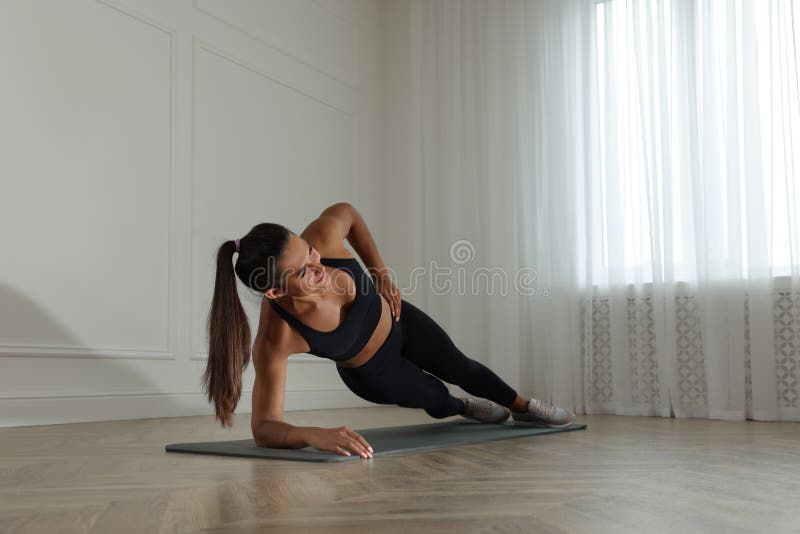 Young Woman Doing Side Plank Exercise at Home Stock Image - Image of ...