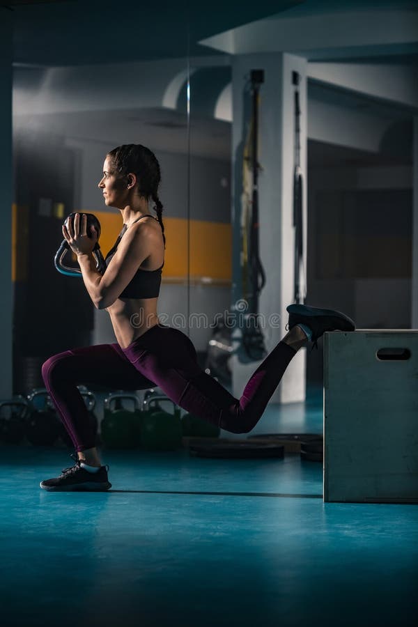 A Young Fit Woman Doing Split Squats Exercise in Gym Stock Photo ...