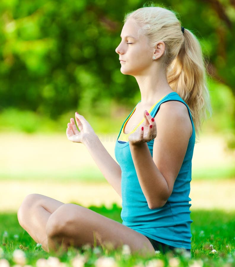 Young Woman Doing Yoga Exercise Stock Photo - Image of grass, forest ...