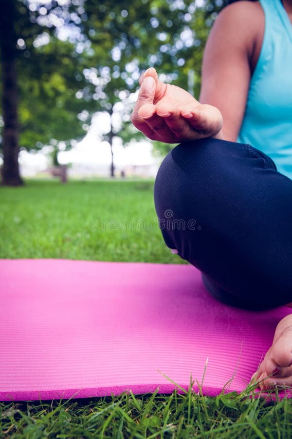 Young Woman Doing Yoga on Mat Stock Image - Image of meditating, green ...