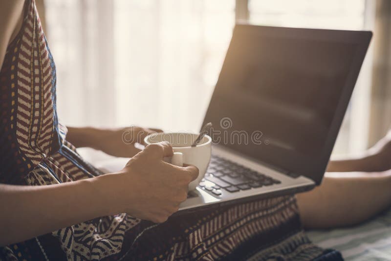 Young Woman Drink of Coffee and Using Laptop Computer Stock Photo ...